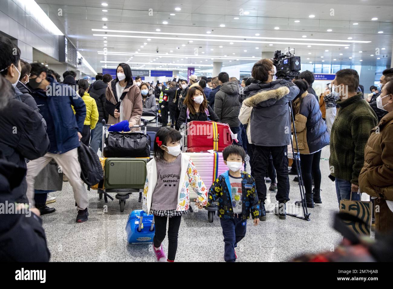 Inbound passengers walk out of the entry passage in the international ...