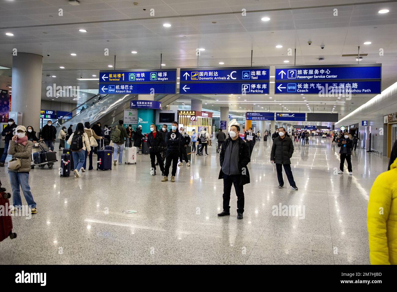 Inbound passengers walk out of the entry passage in the international ...