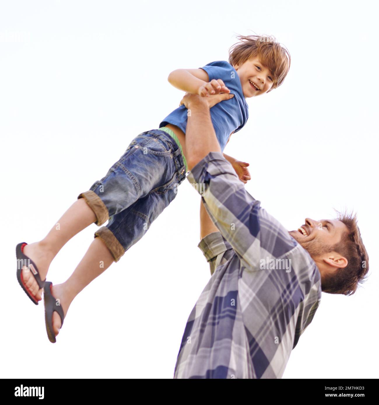 When I grow up Im going to be strong like dad. a young father lifting ...