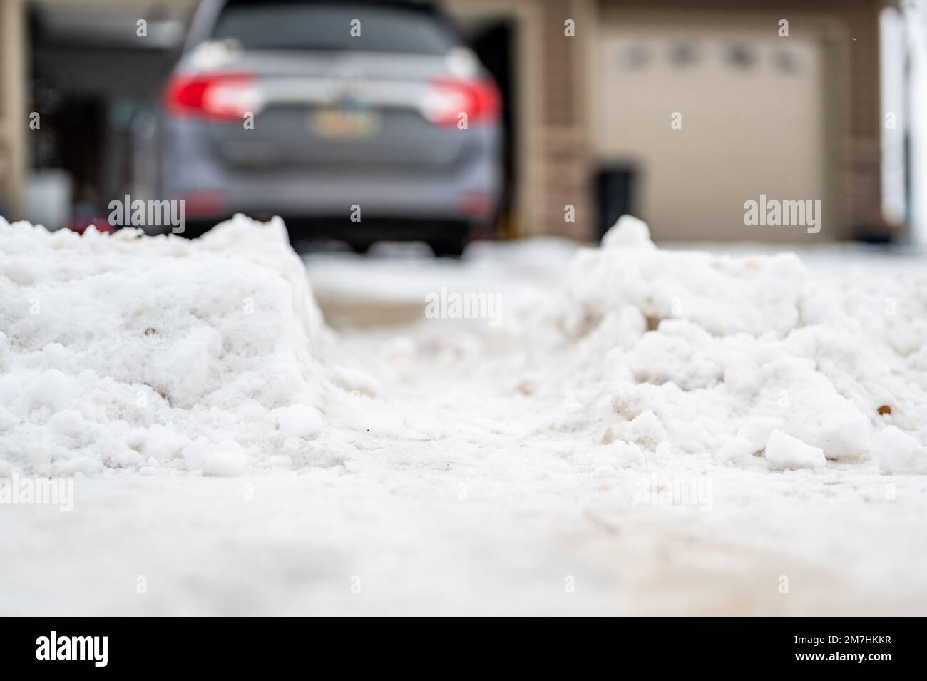Snowbank at the end of a driveway left after city snowplows cleared a ...