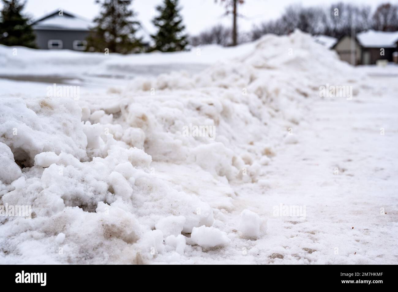 Snowbank at the end of a driveway left after city snowplows cleared a ...