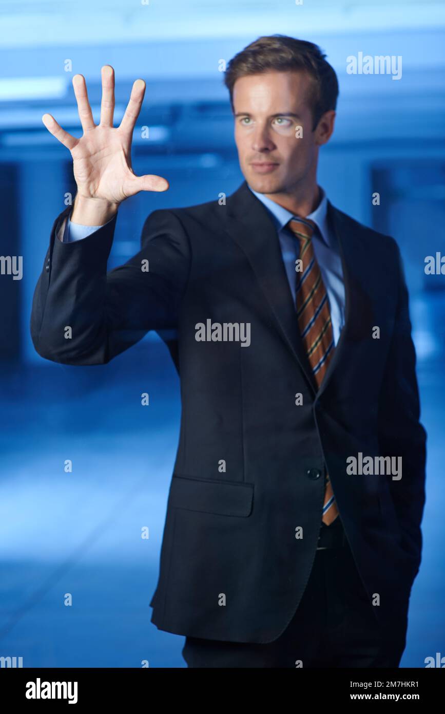 Touching the future. a handsome young businessman using a digital ...