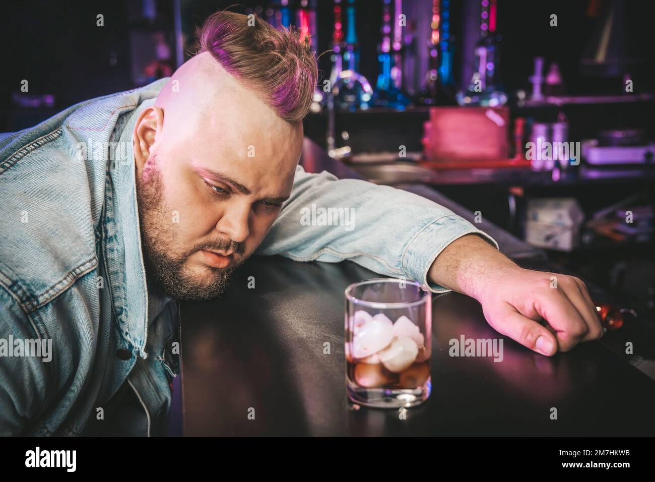 a drunk brutal man with an alcoholic cocktail in a glass. The concept ...