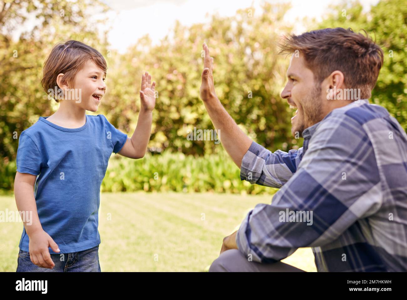 We make a great team. a young father giving his son a high-five Stock ...