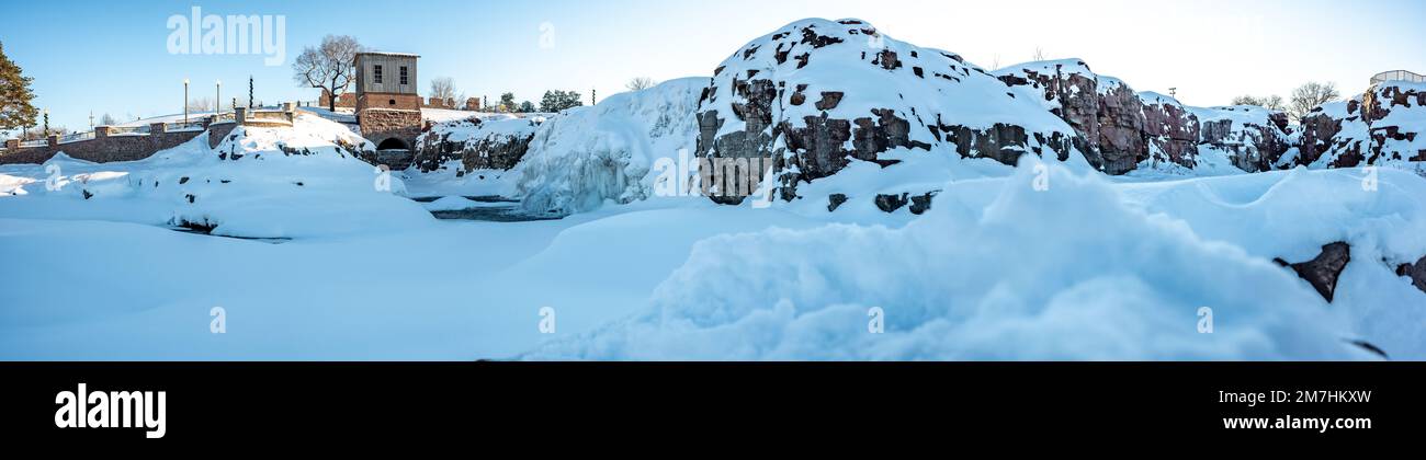 Sioux Falls Park during winter with frozen waterfall and snow cover ...