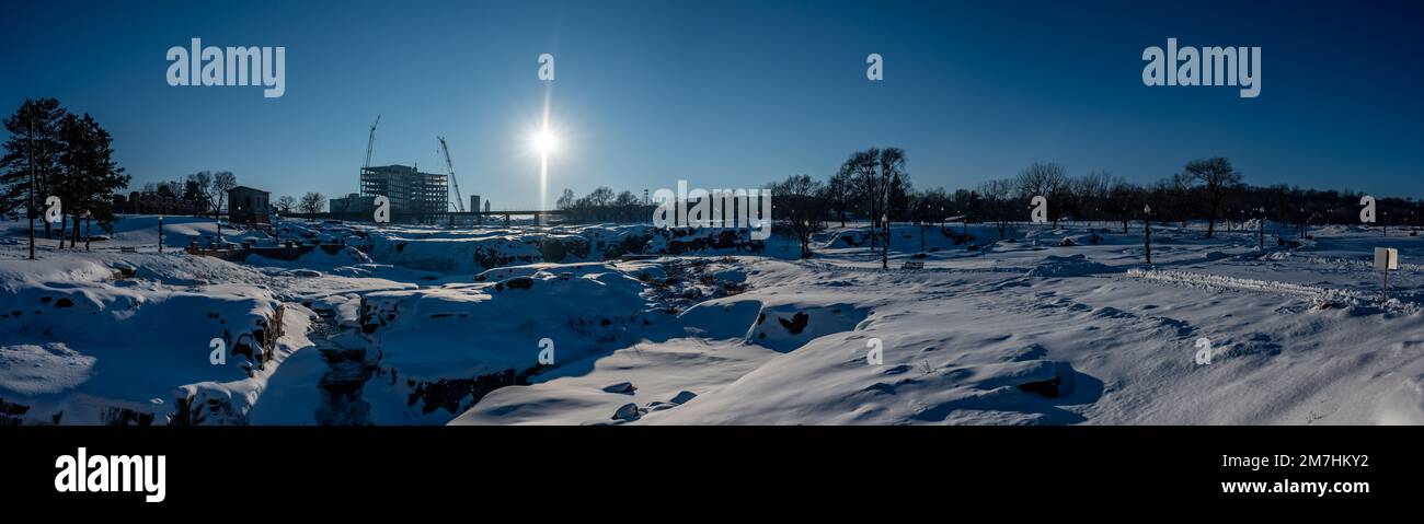 Sioux Falls Park during winter with frozen waterfall and snow cover ...