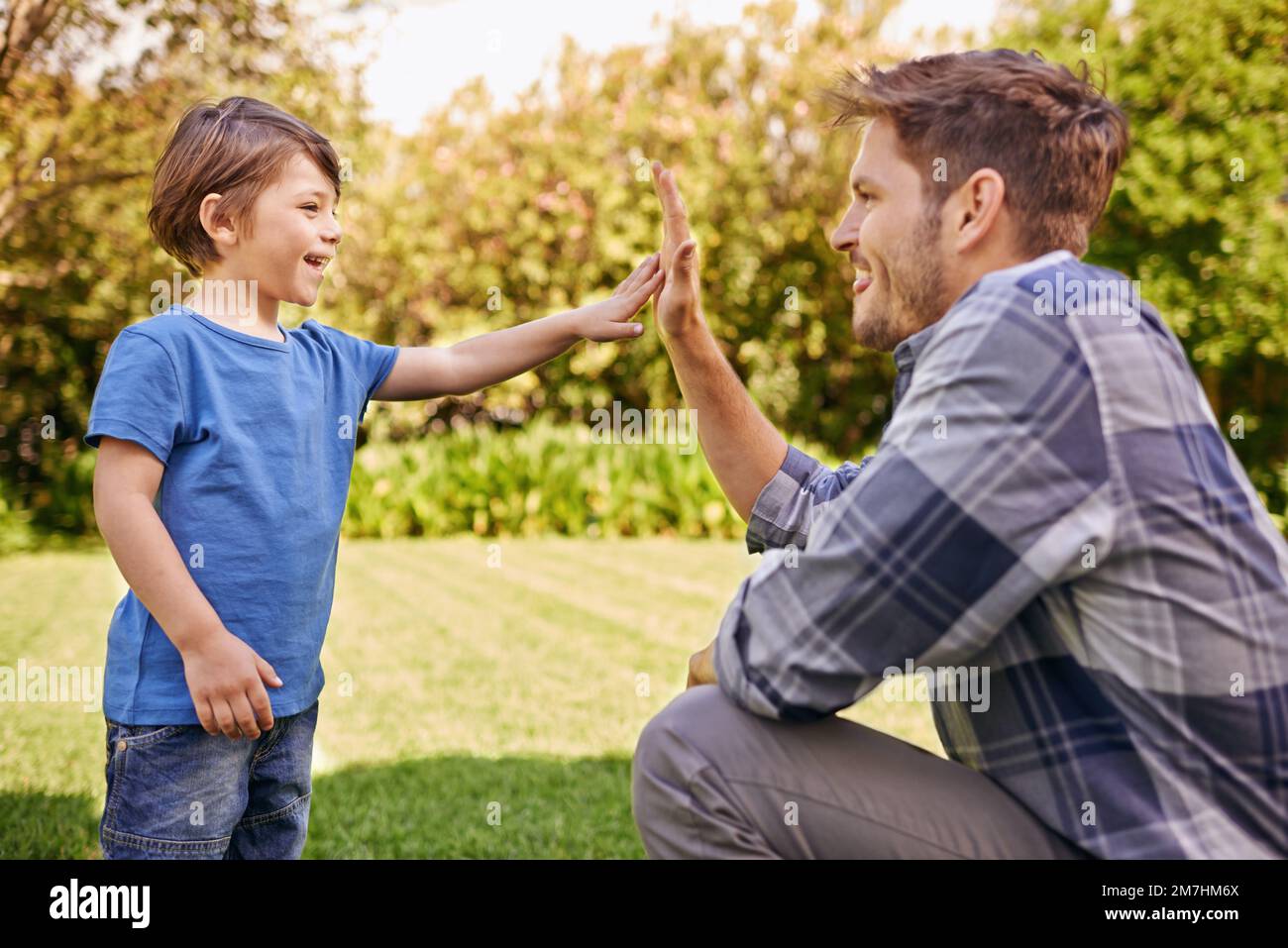 Boy giving father high five hi-res stock photography and images - Alamy