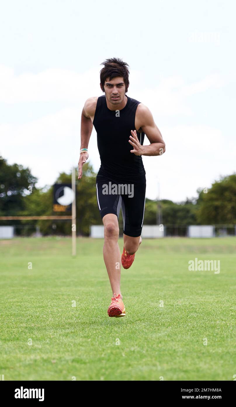 Trying to beat his personal best. A young male athlete training on a ...
