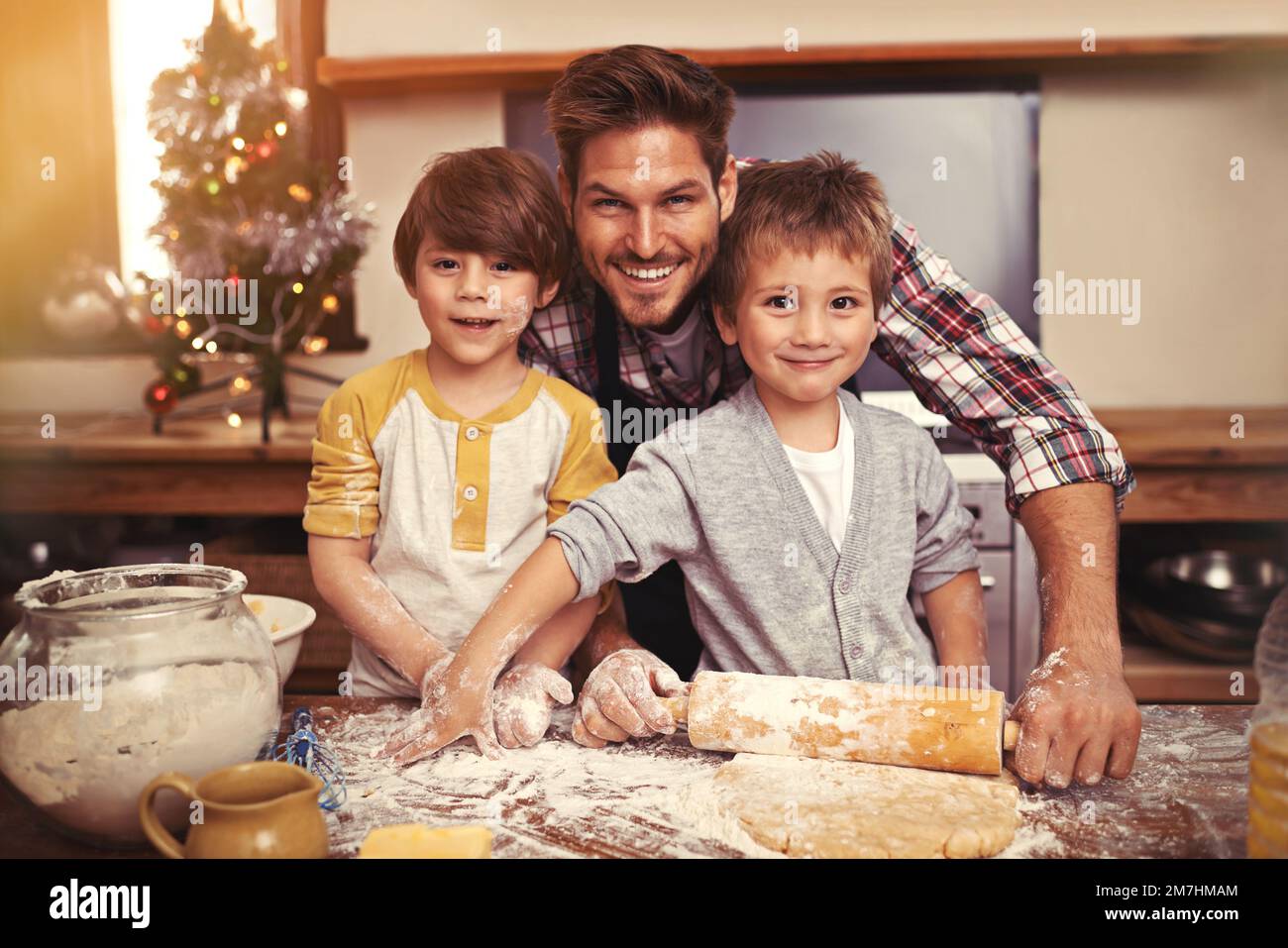 Baking something sweet for mom. two young brothers baking with their ...