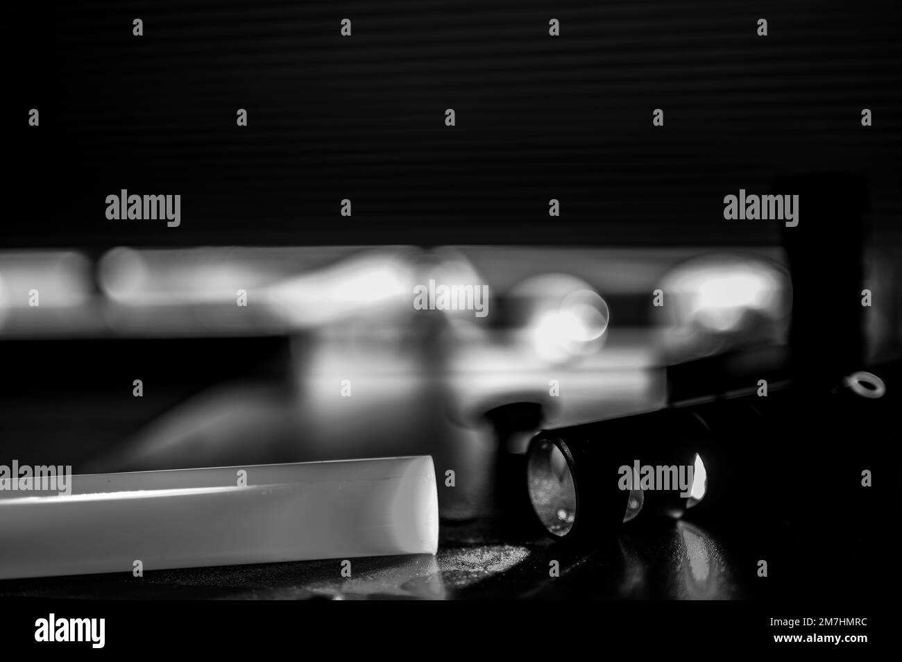 Assorted parts to build a laser sword from a kit with a hilt, neon ...