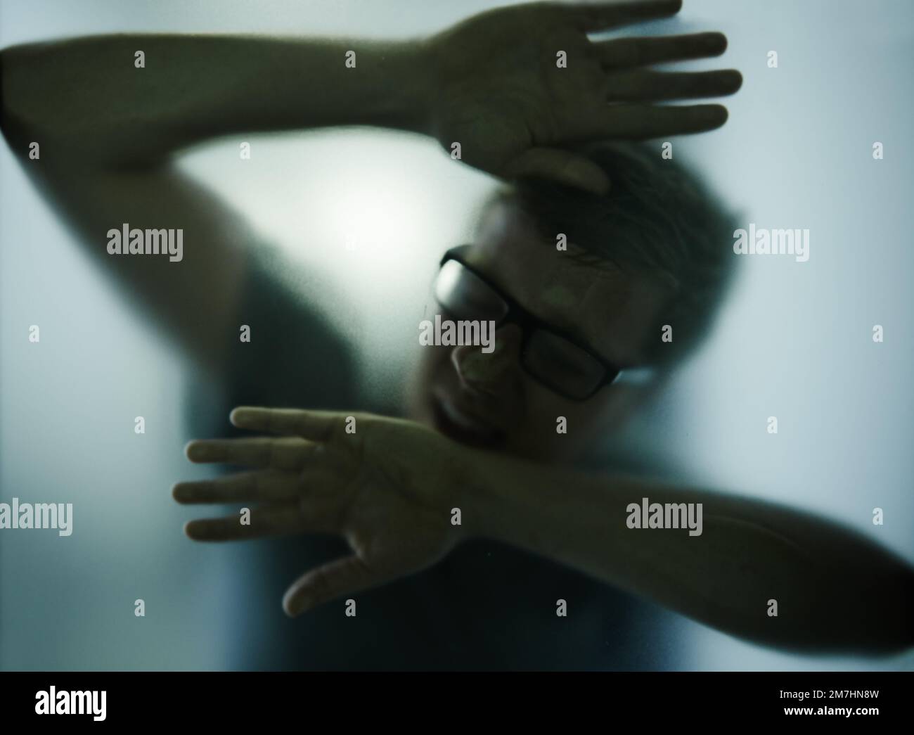 Is anyone out there...Anybody. a man behind a glass window during ...