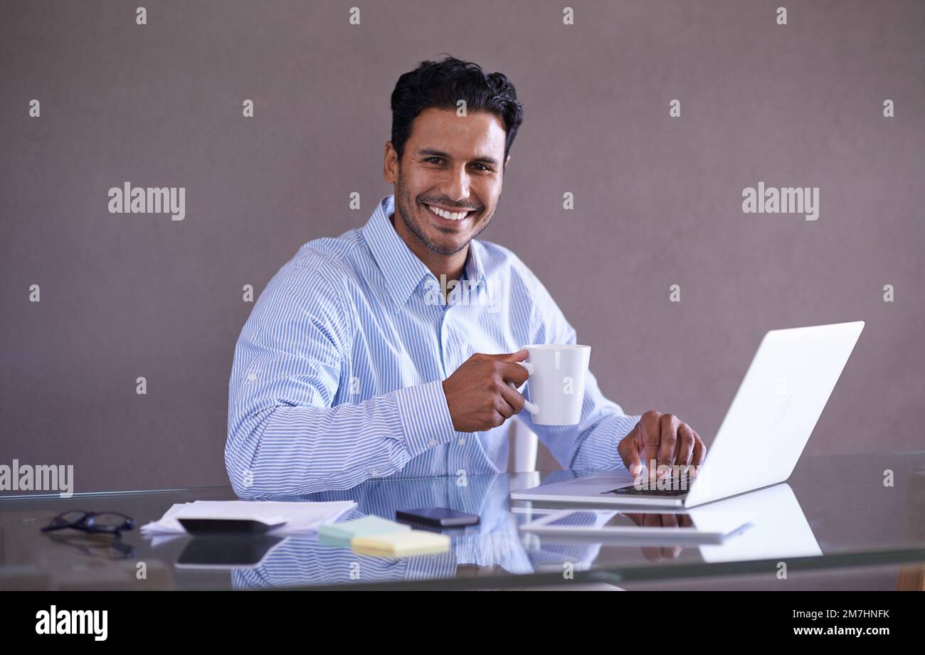 Hes working hard to complete his tasks. a handsome young businessman ...