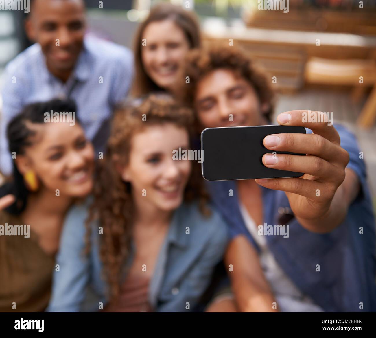 Capturing their moments of friendship. a group of friends taking a self ...