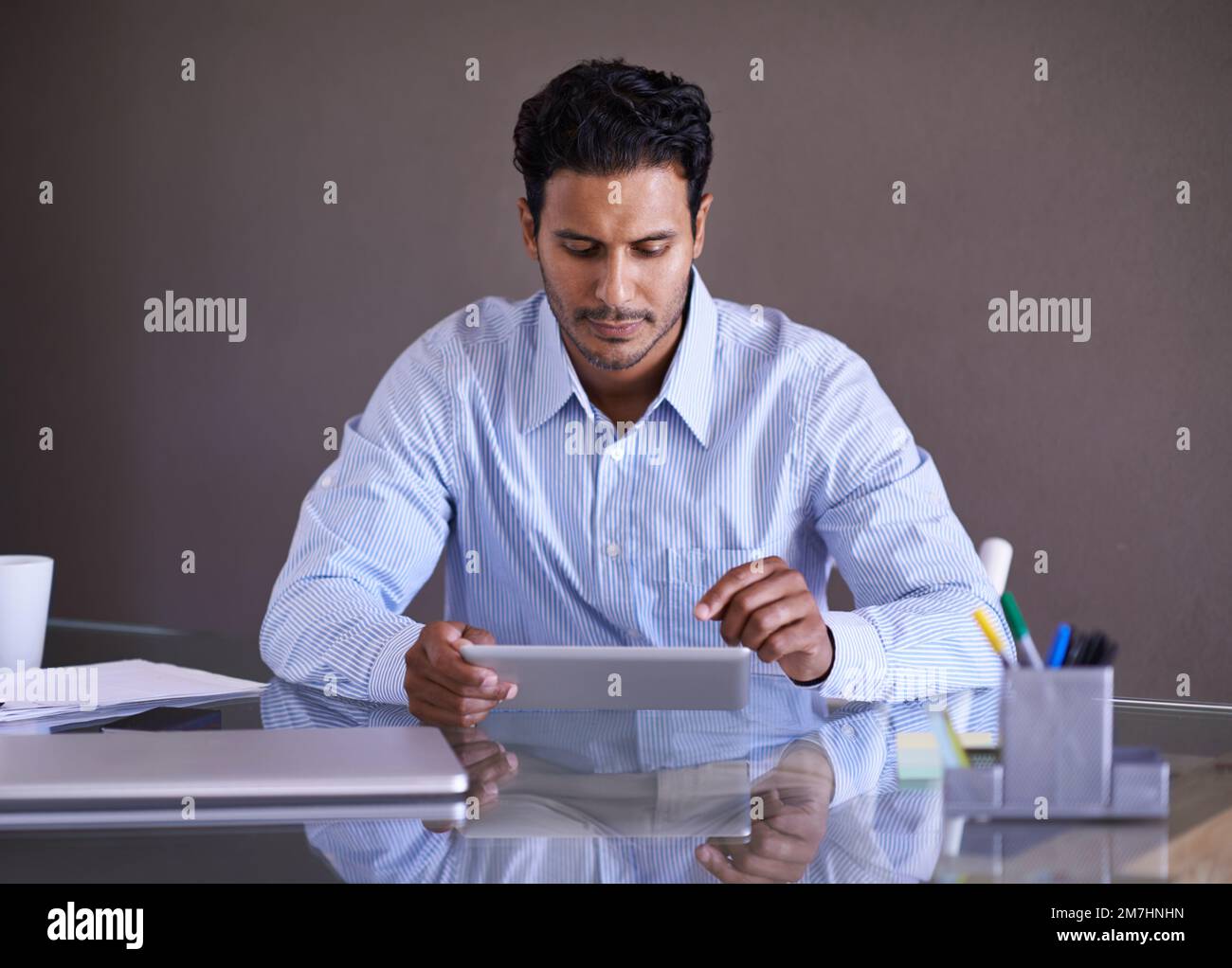 Hes working hard to complete his tasks. a handsome young businessman ...