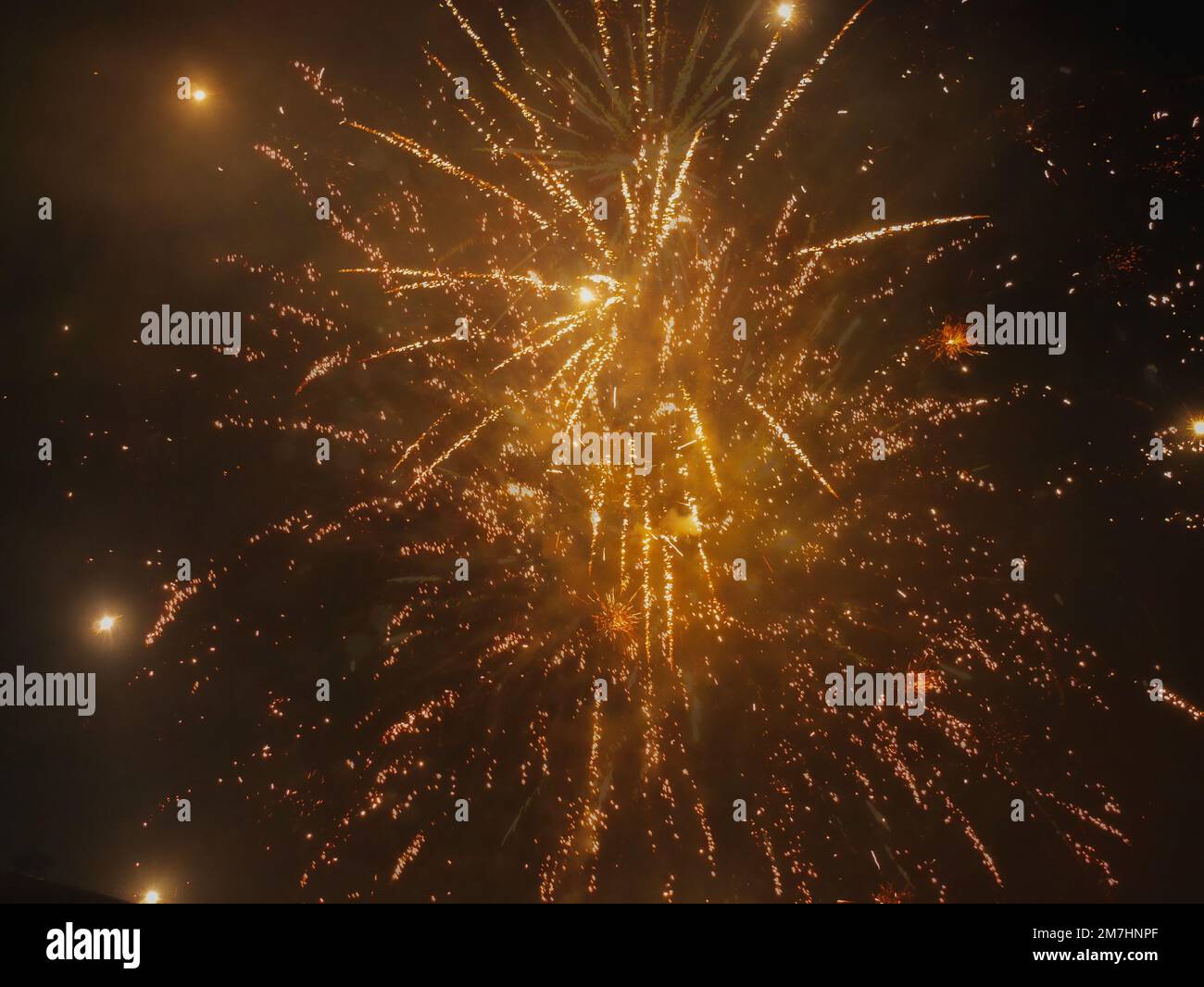 The orange fireworks on a dark night sky perfect for backgrounds and ...