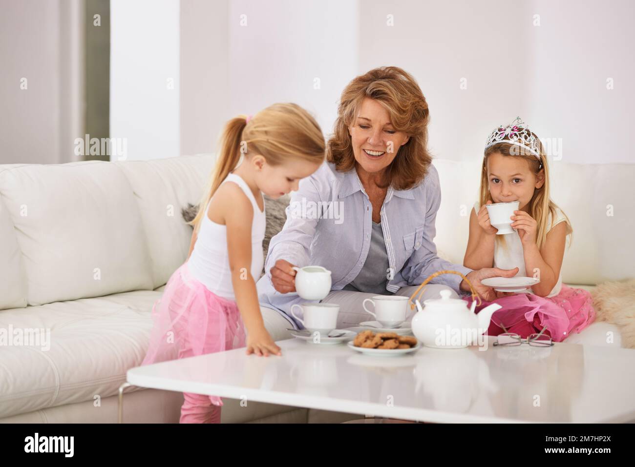 Girl time. a grandmother and her granddaughters enjoying a tea party ...