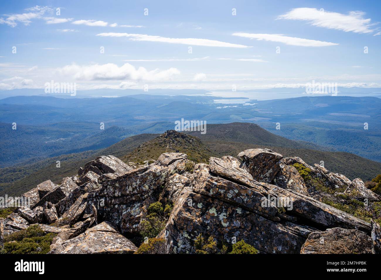 hiking up to the summit of a rocky mountain in australia in spring ...
