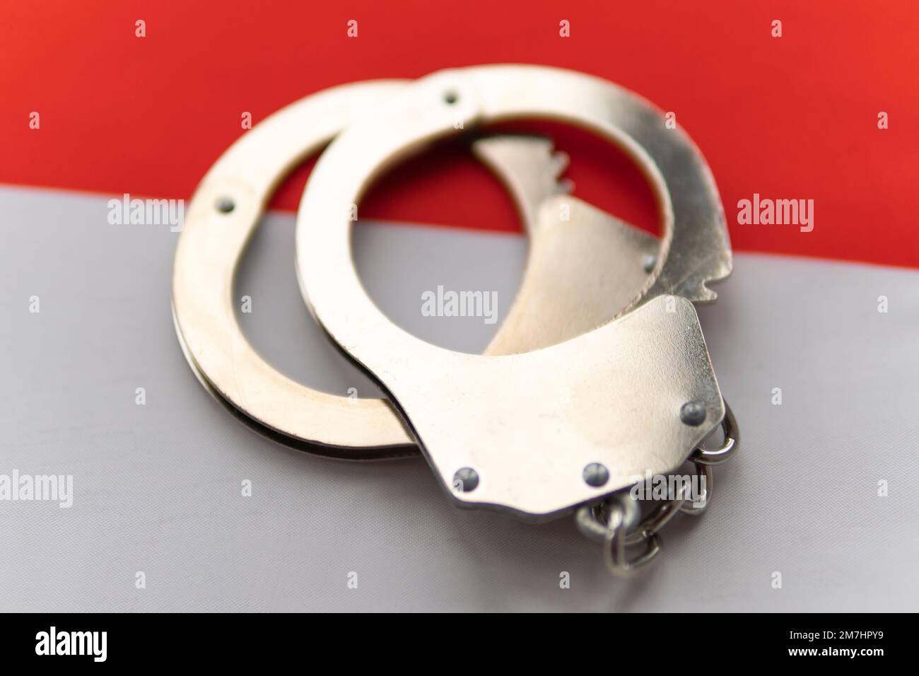 indonesia flag and police handcuffs. The concept of crime and offenses ...