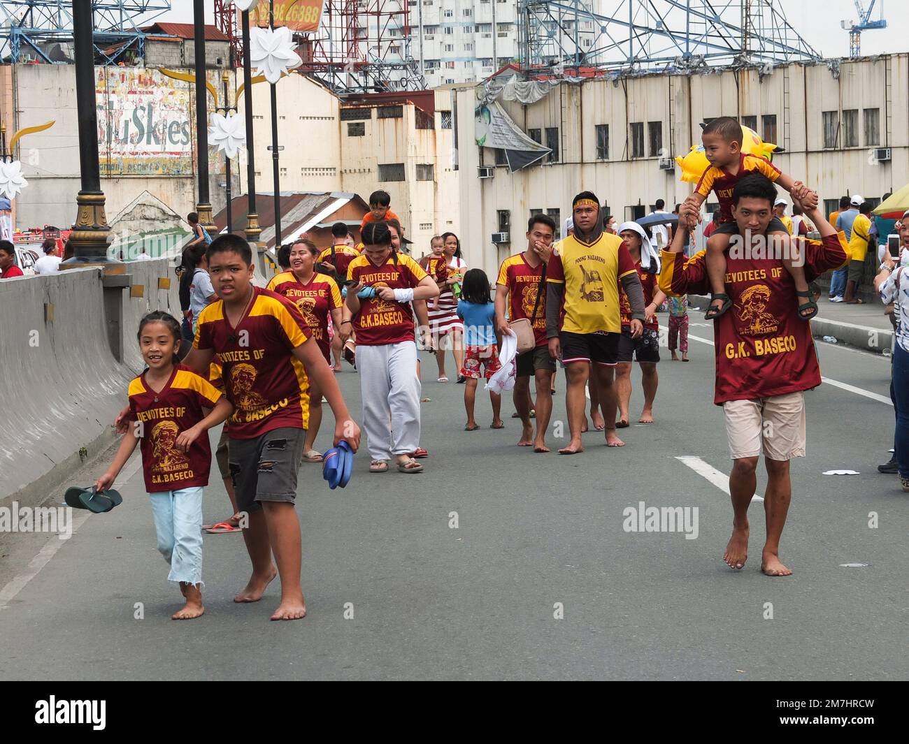 Barefooted devotees walk towards Quezon Bridge in Quiapo, Manila. After ...