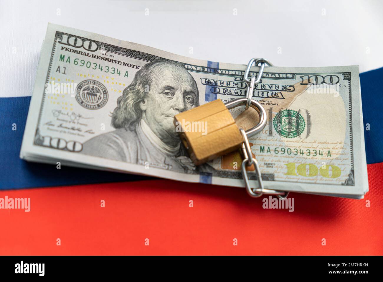 money dollars in a chain with a lock on the background of the Russian ...