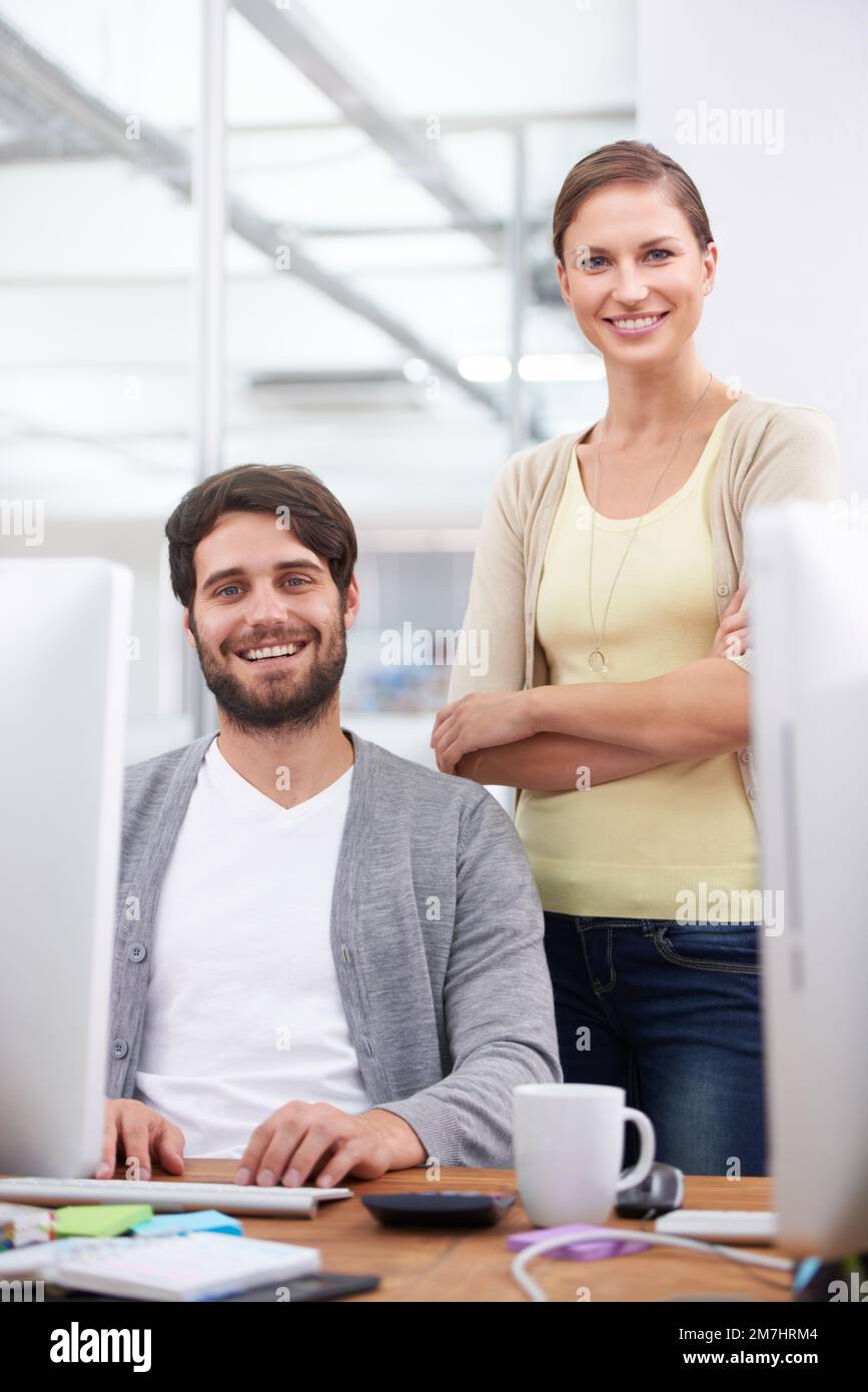 What a dynamic duo. two young coworkers smiling at the camera Stock ...