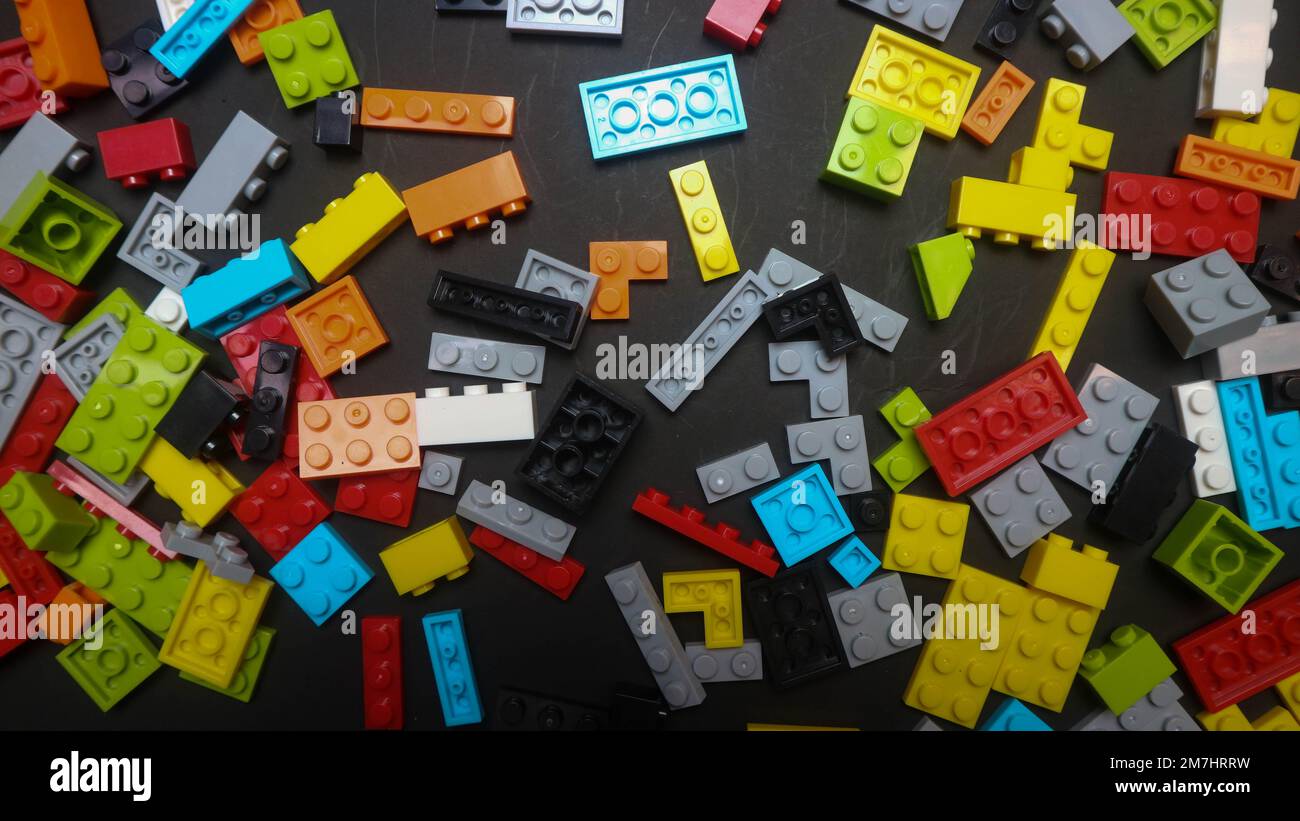 Plastic toy blocks on black background Stock Photo - Alamy