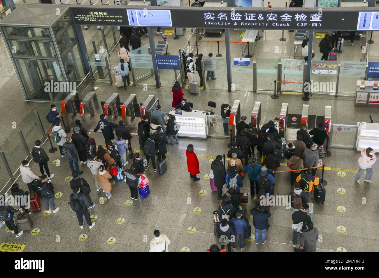 Passengers line up to get in the station at Shanghai Hongqiao Railway ...
