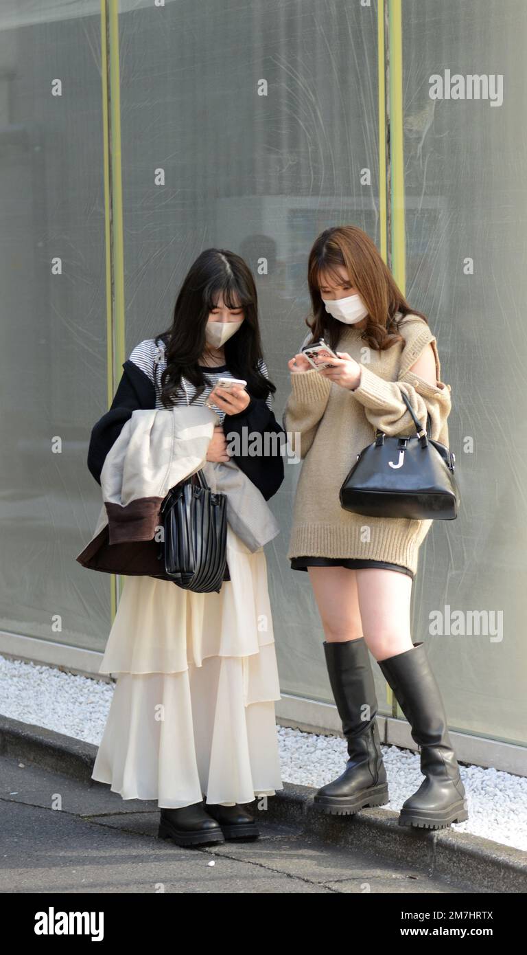 Stylish Japanese women using their smartphone in Harajuku, Tokyo, Japan ...