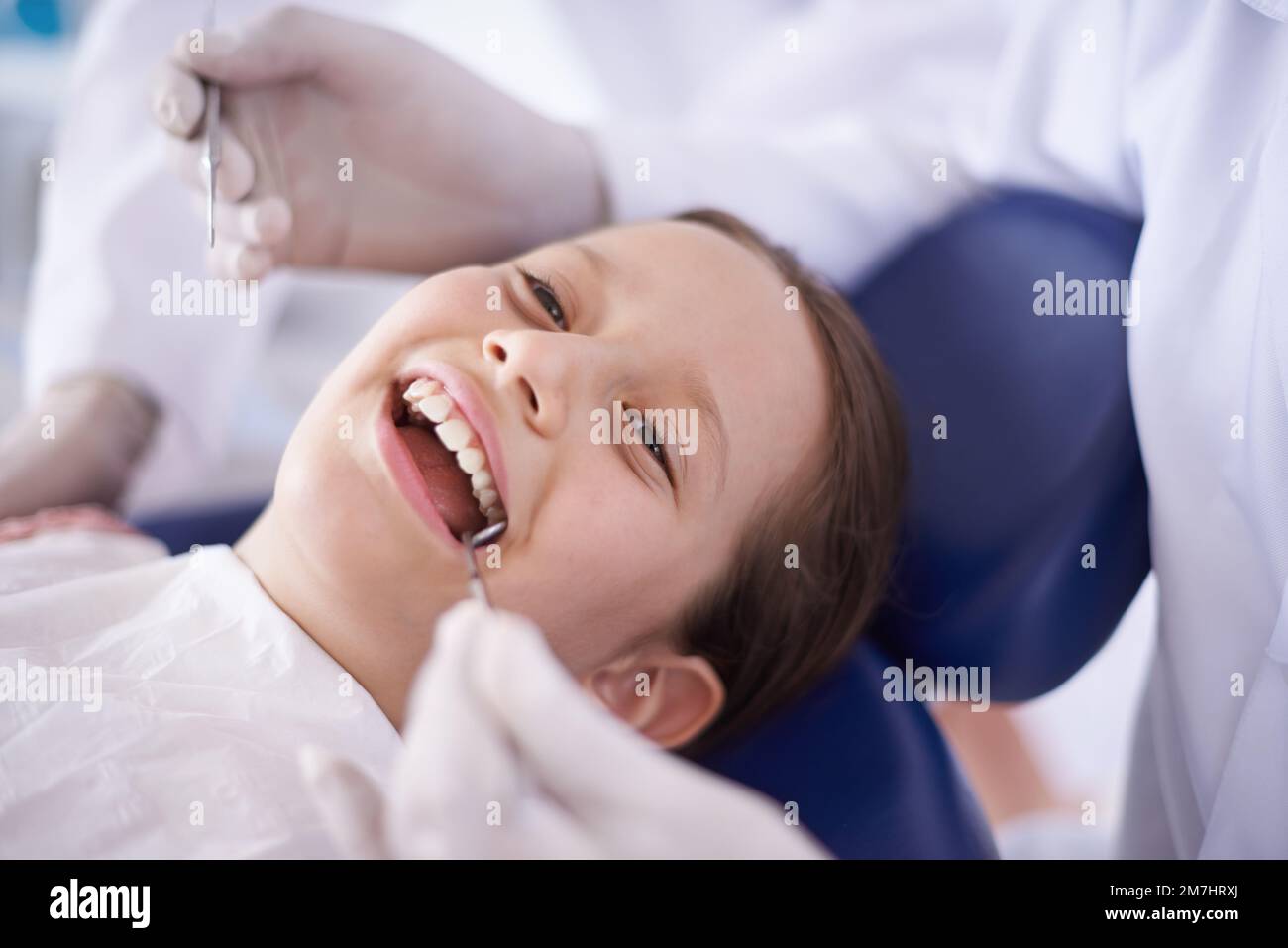 At the dentist for her regular check-up. A young girl at the dentist ...