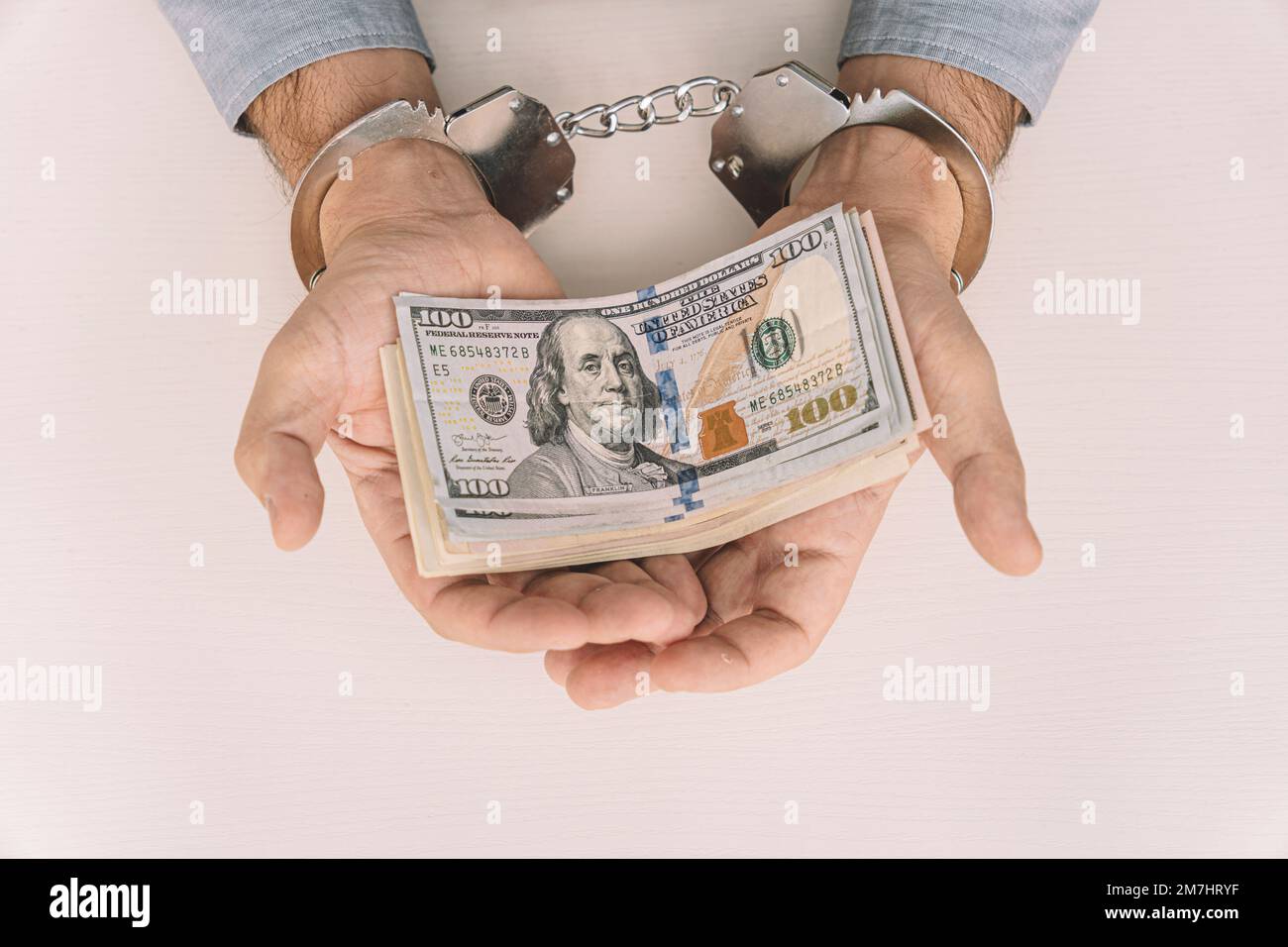 Business man in handcuffs arrested for bribe. money dollars in a man's ...