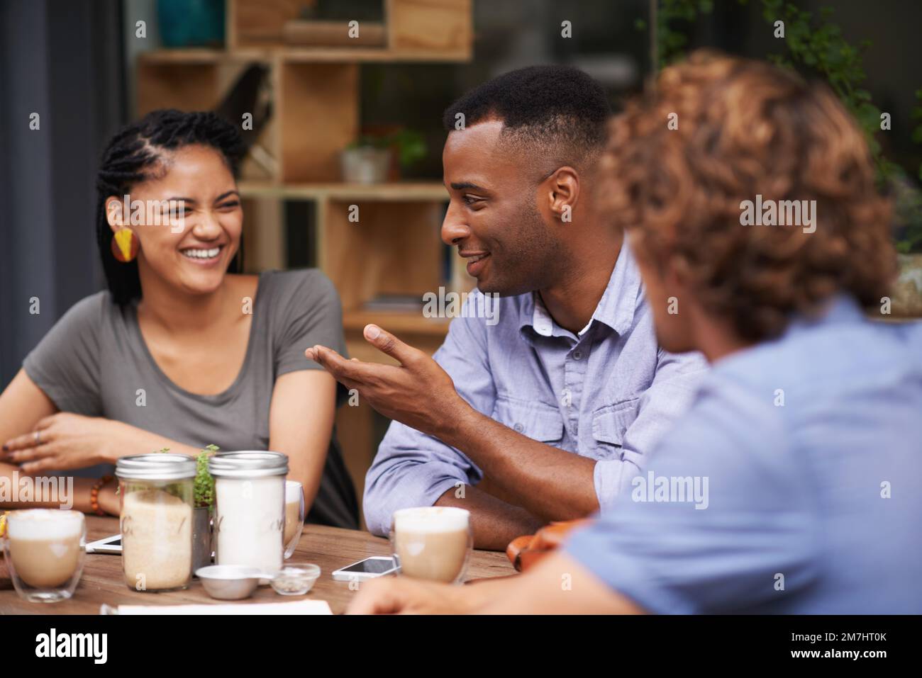 This is the best place in town. A group of young friends sitting ...