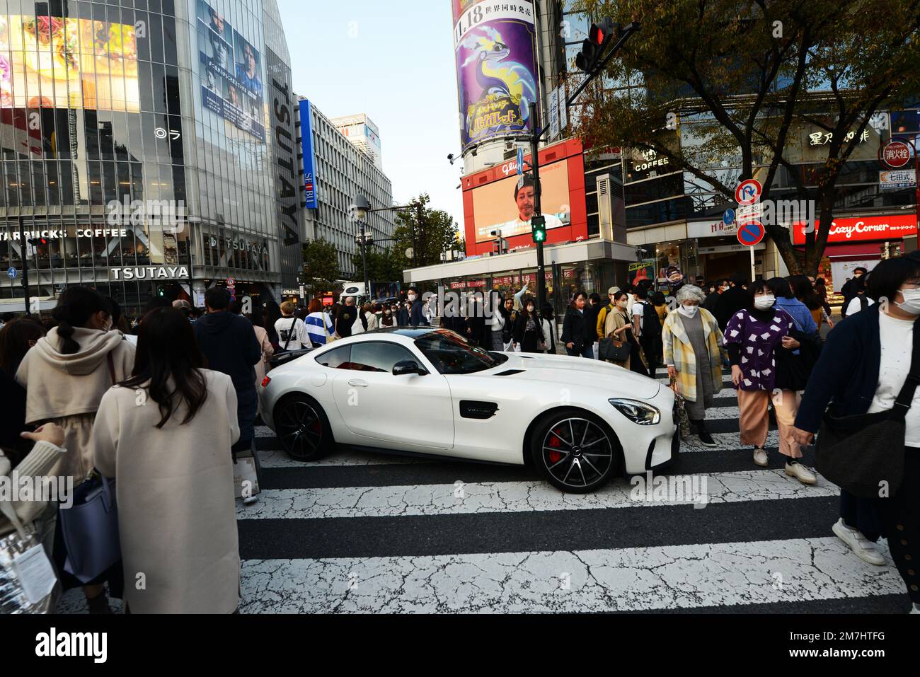 An AMG sports car between the pedestrians at the Shibuya Crossing ...