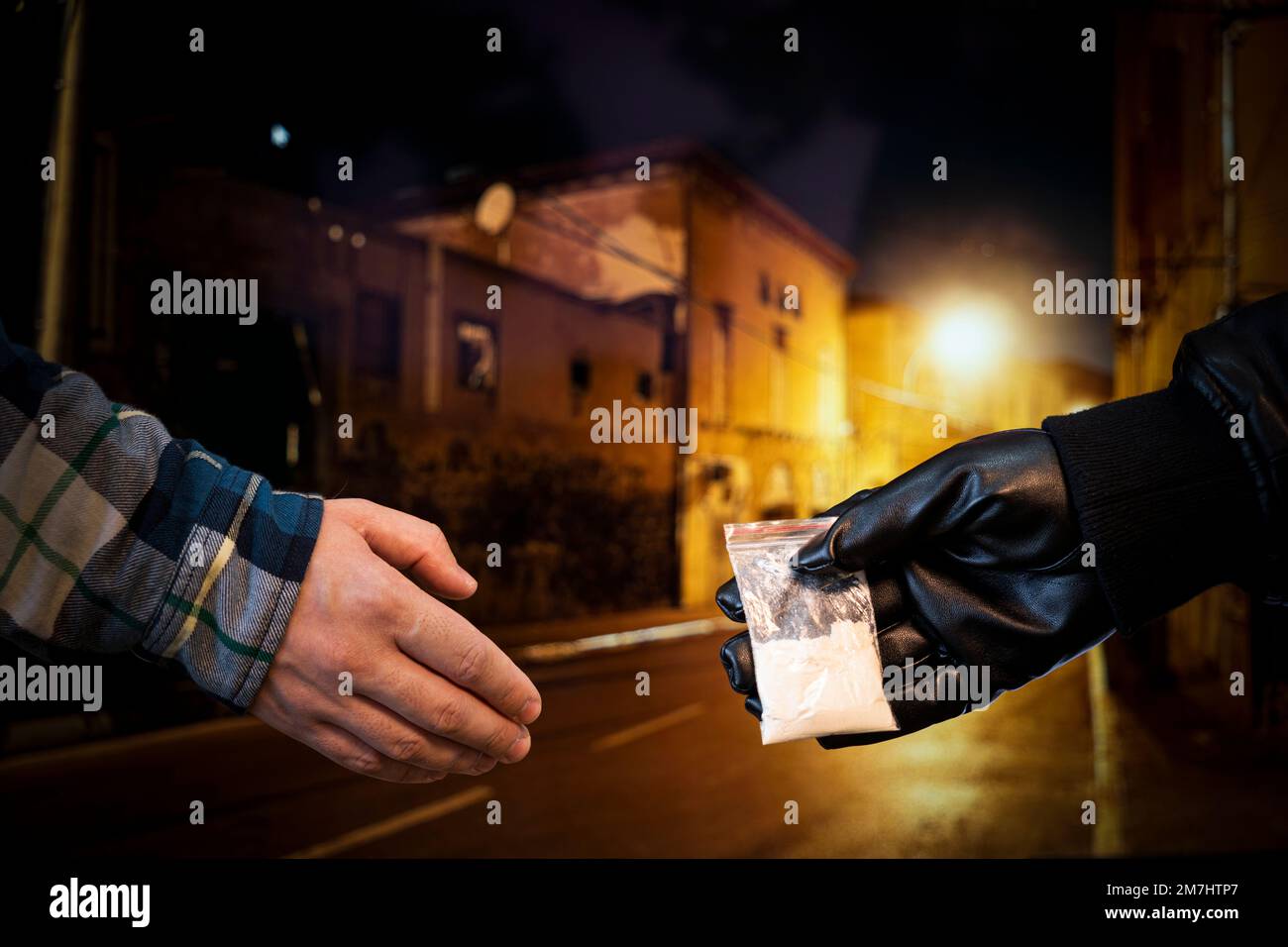 Drug dealer selling junkie. Man hand holds plastic packet or bag with ...