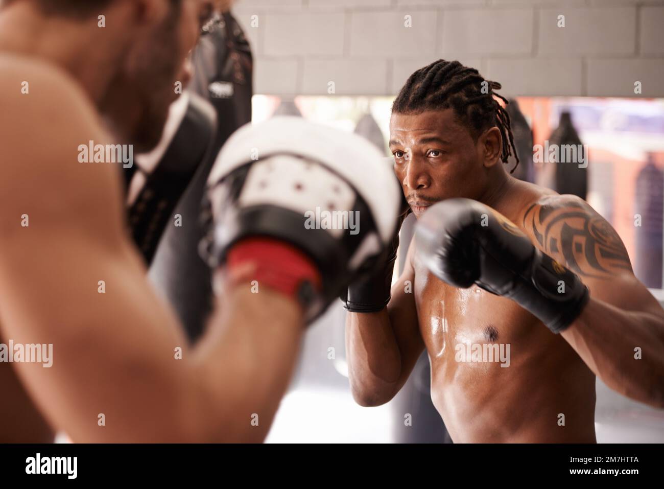 Jab workout. a young boxer practicing his punching with a partner Stock ...
