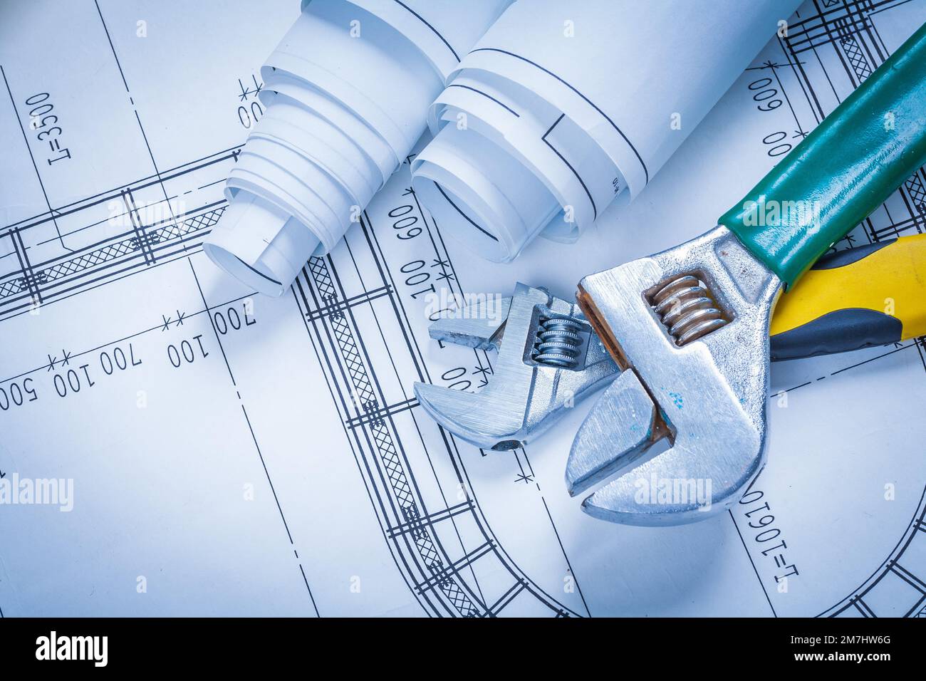 Adjustable spanners and blueprint rolls construction concept Stock ...