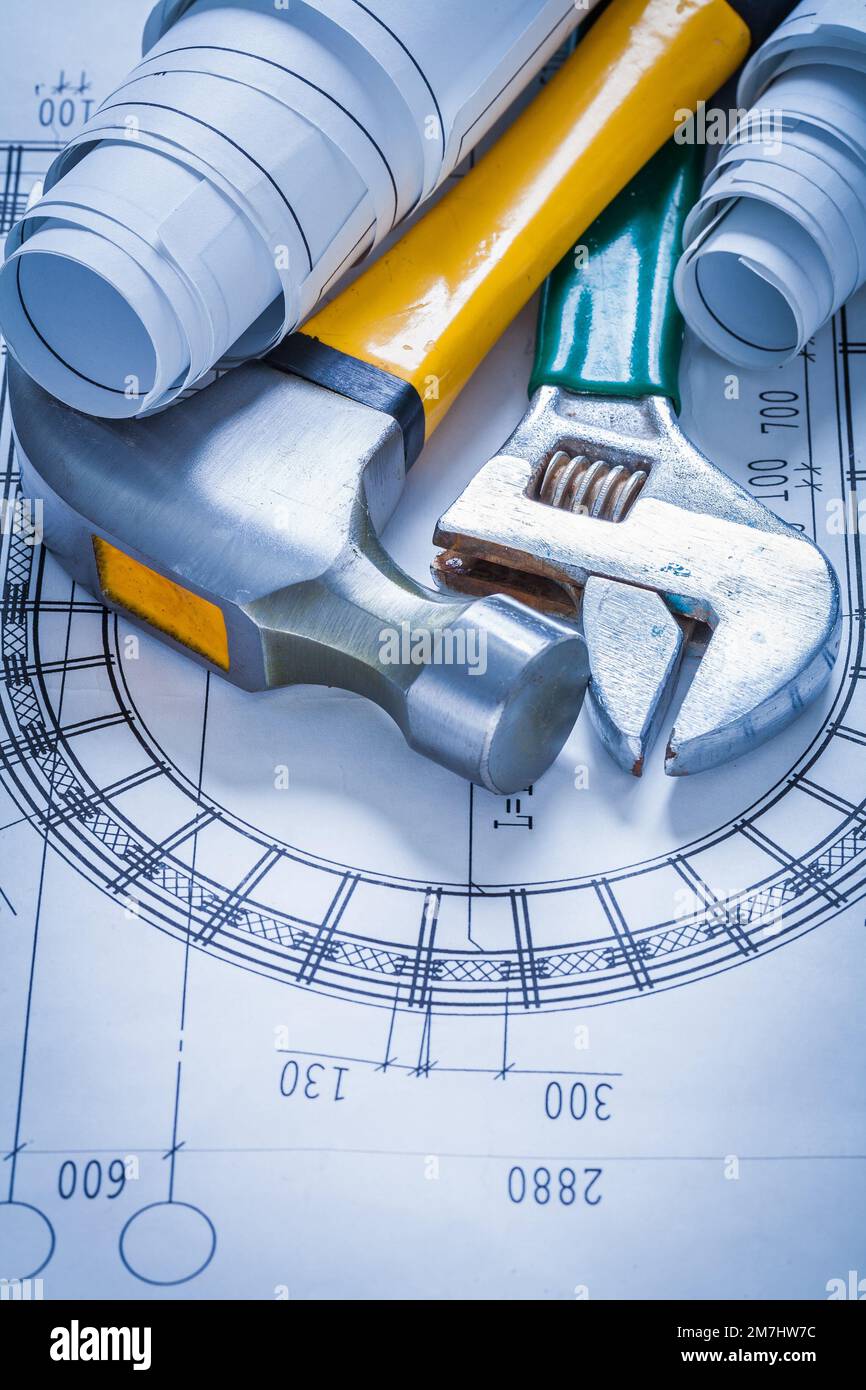 Adjustable spanner rolled up construction plans and claw hammer ...