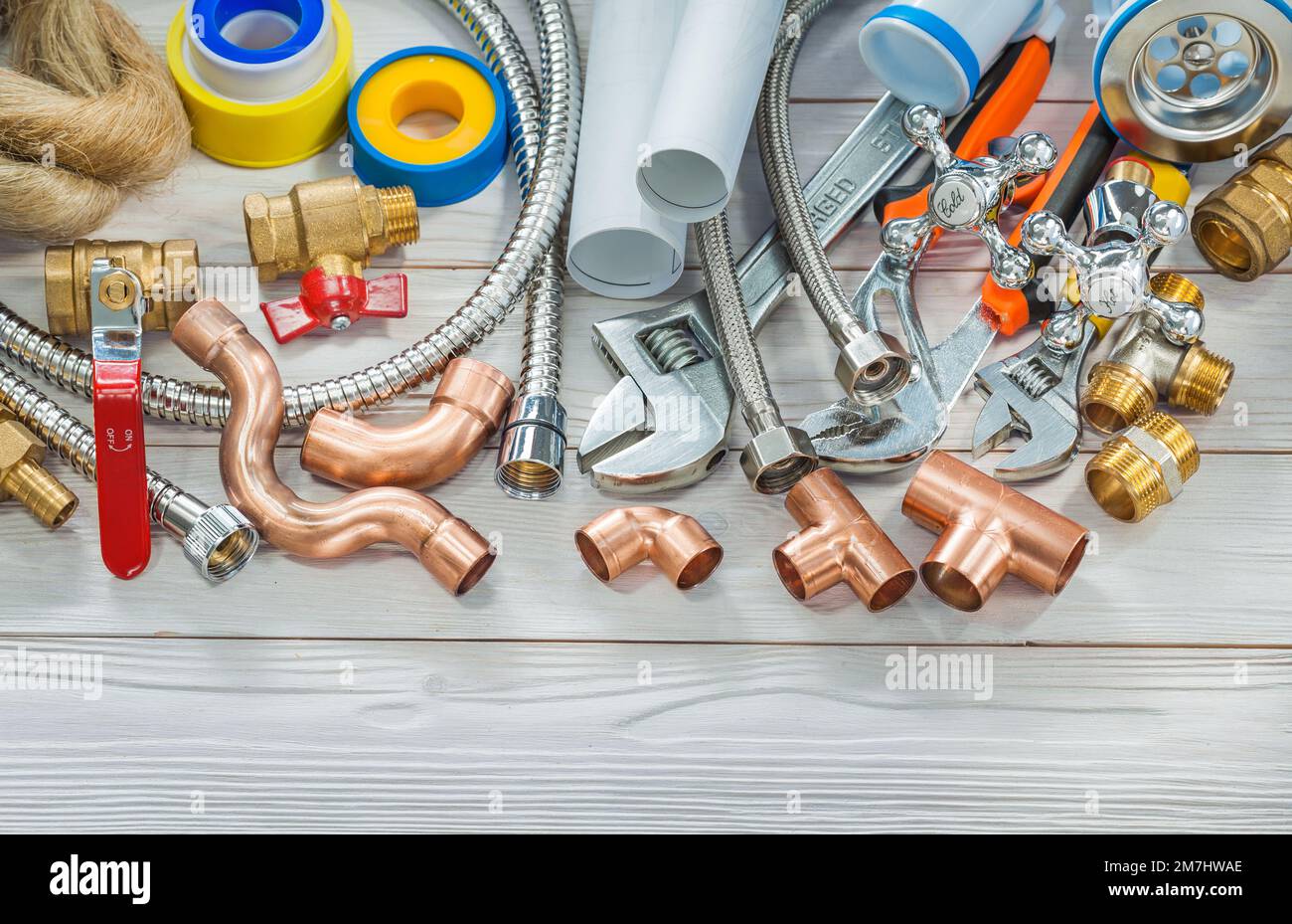 big set of plumbers tools and accessories on vintage white painted wood ...