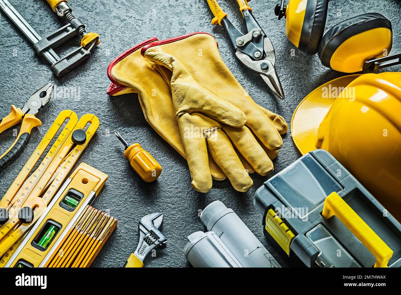 big set of construction tools with gloves in centre on black background ...