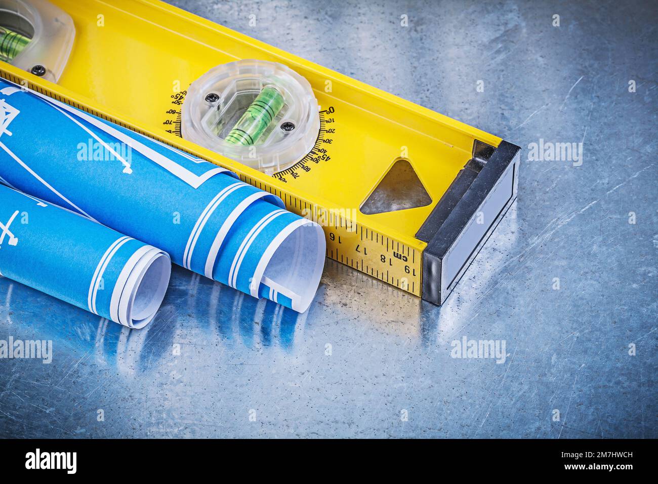 Blue blueprints construction level on metallic background maintenance ...