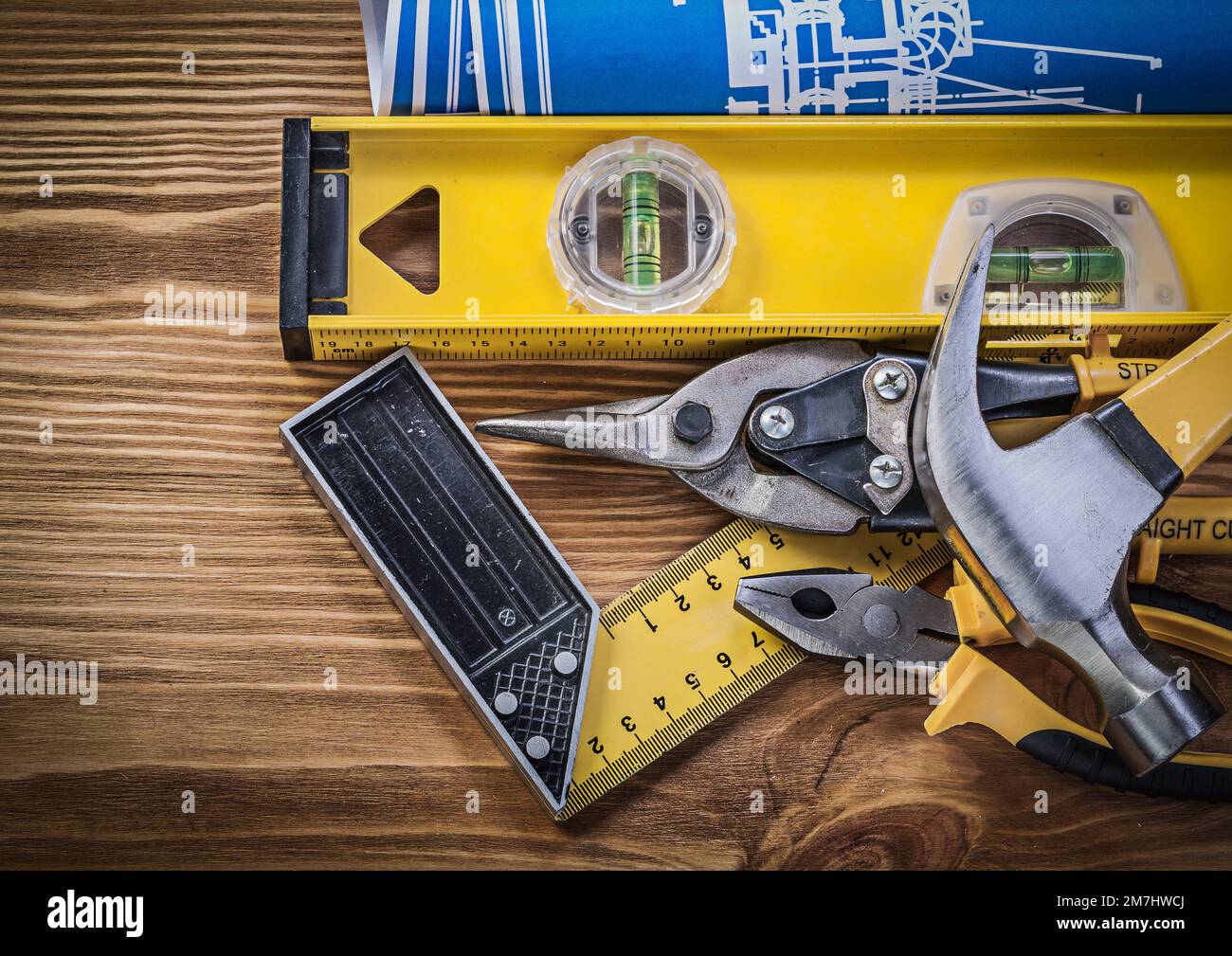 Blue blueprints construction level try square claw hammer pliers tin ...