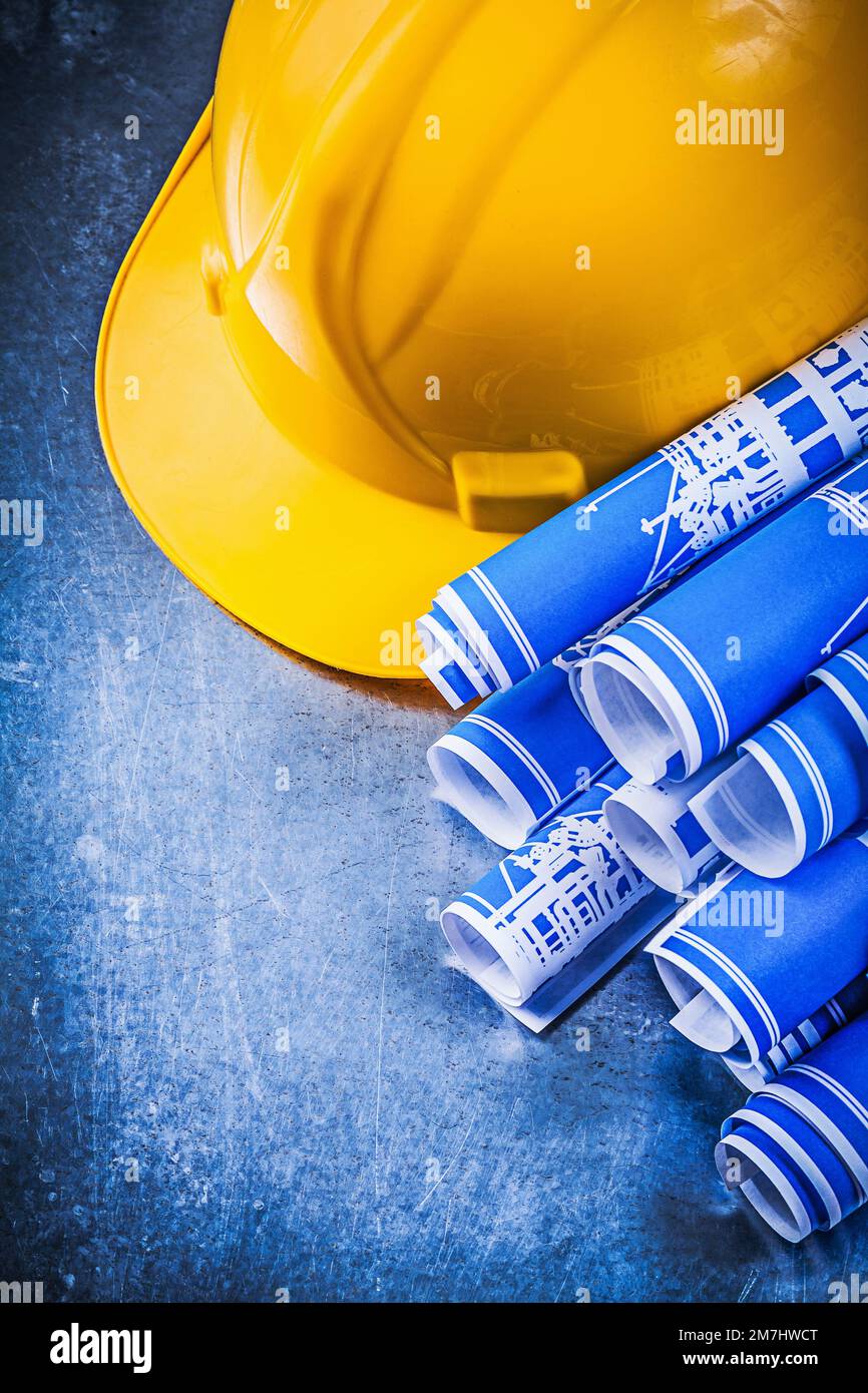 Blue blueprints building helmet on metallic background construction ...