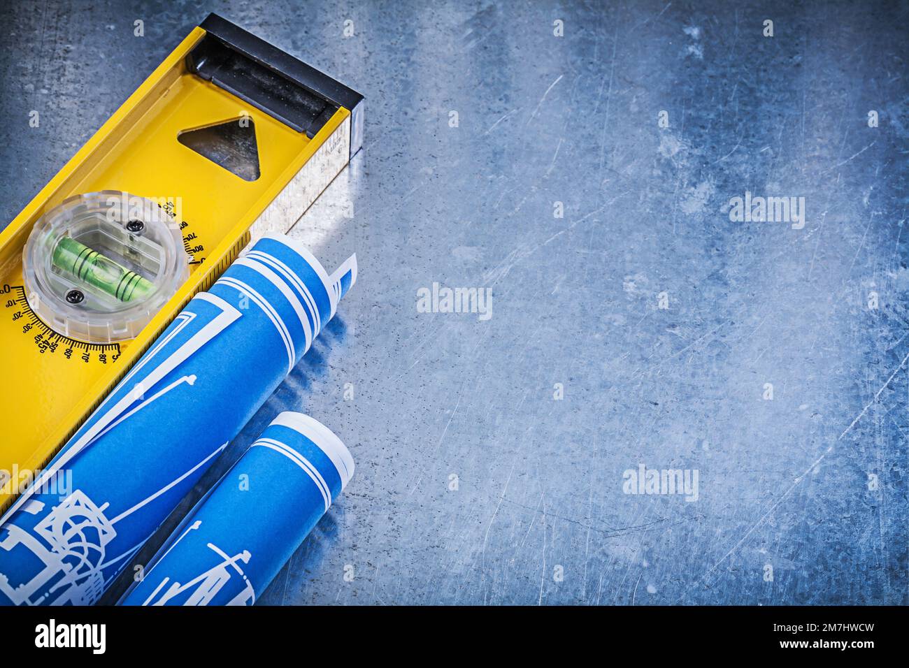Blue blueprints construction level on metallic background copyspace ...