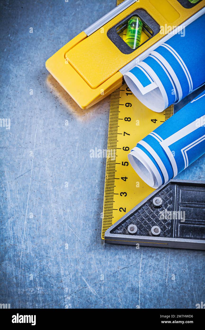 Blue blueprints construction level try square on metallic background ...