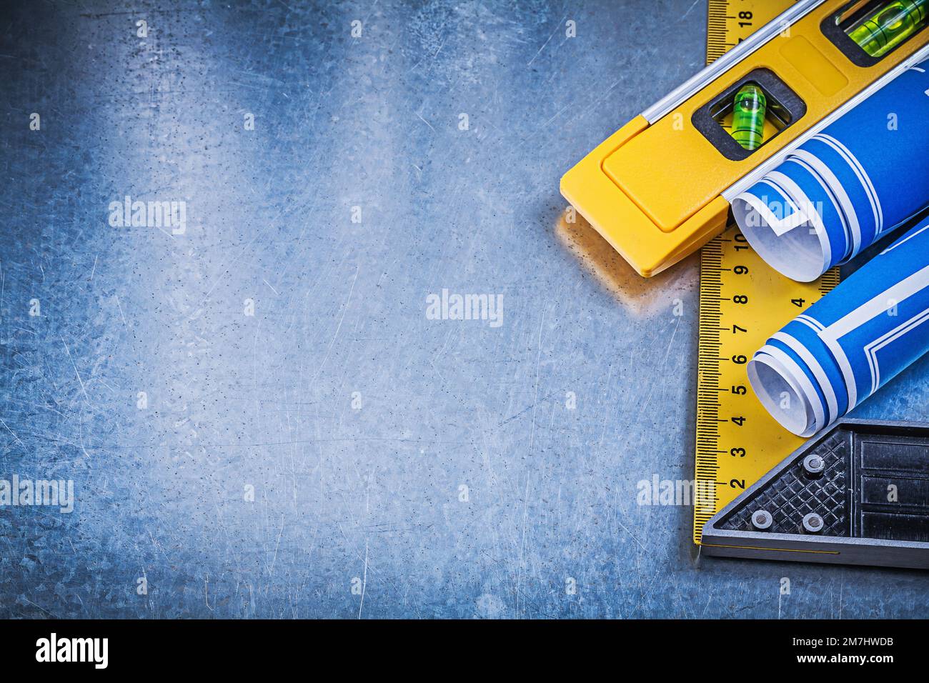 Blue blueprints construction level square ruler on metallic background ...