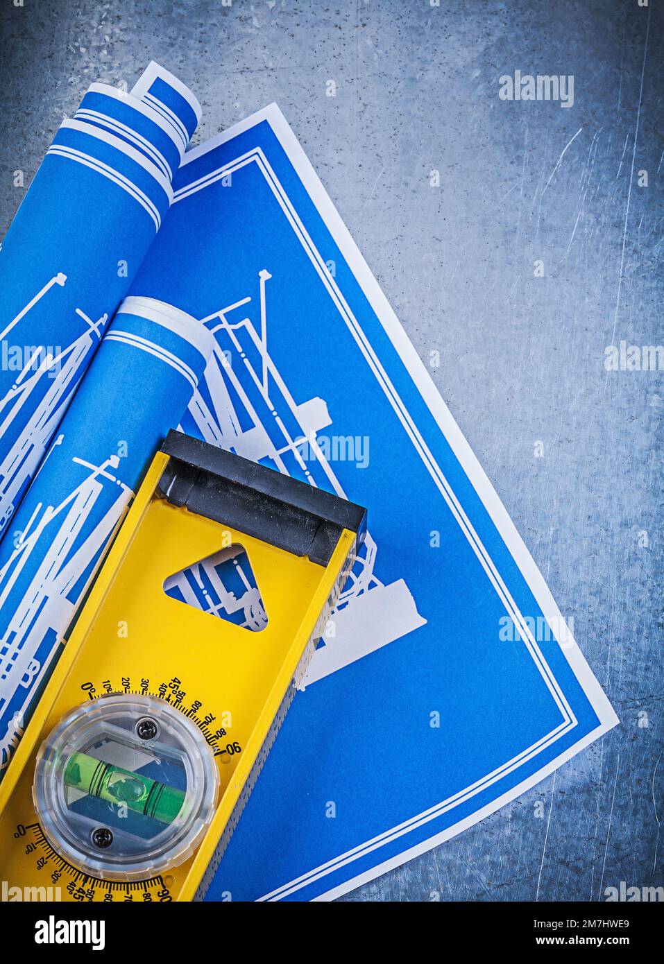 Blue blueprints yellow construction level on metallic background Stock ...