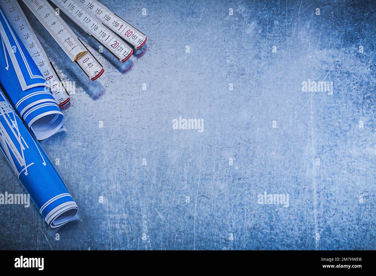 Blue blueprints wooden meter on metallic background copyspace ...