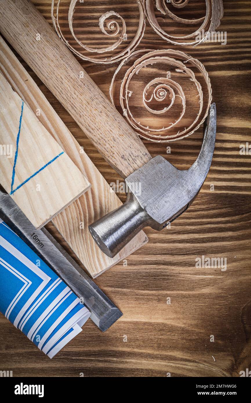 Blue construction plan claw hammer firmer chisel wooden studs shavings ...