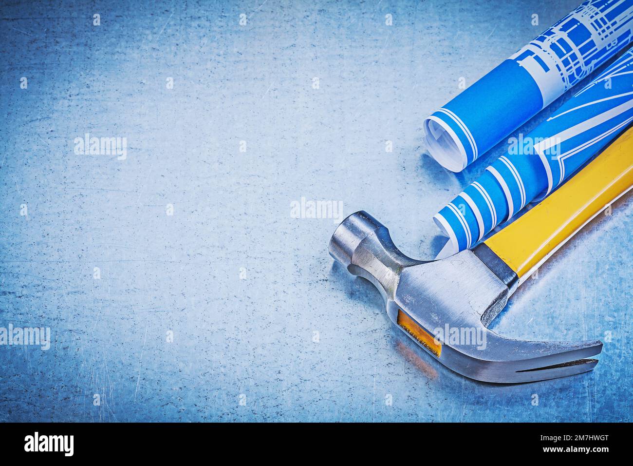 Blue construction plans claw hammer on metallic background Stock Photo ...