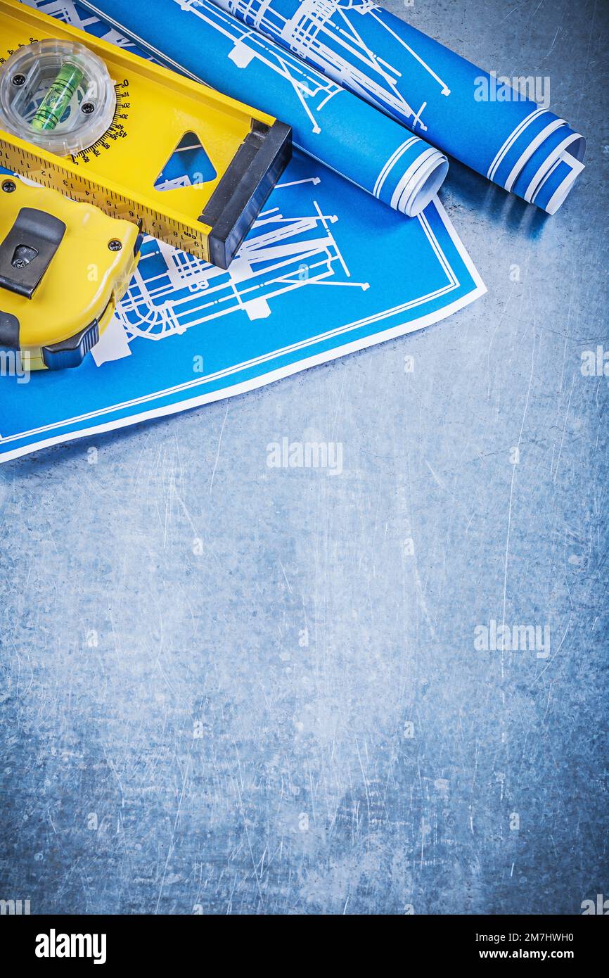 Blue construction plans level tape measure on metallic background Stock ...