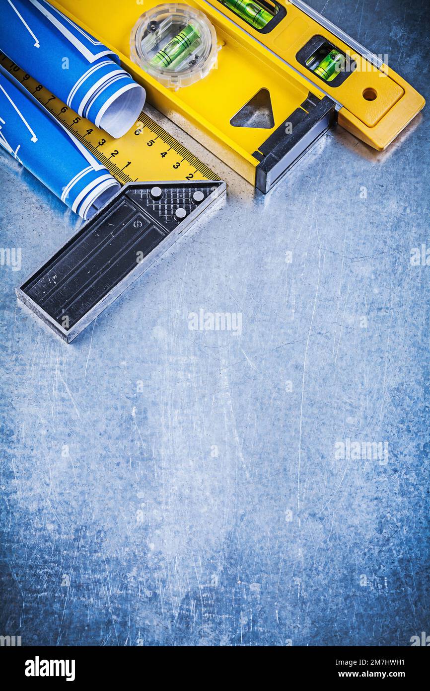 Blue construction plans levels try square on metallic background Stock ...